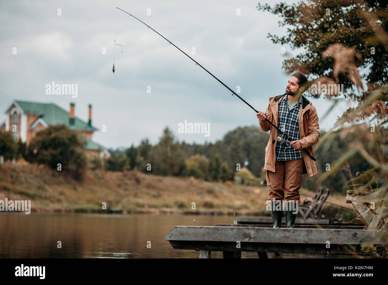 man fishing with rod at lake Stock Photo - Alamy