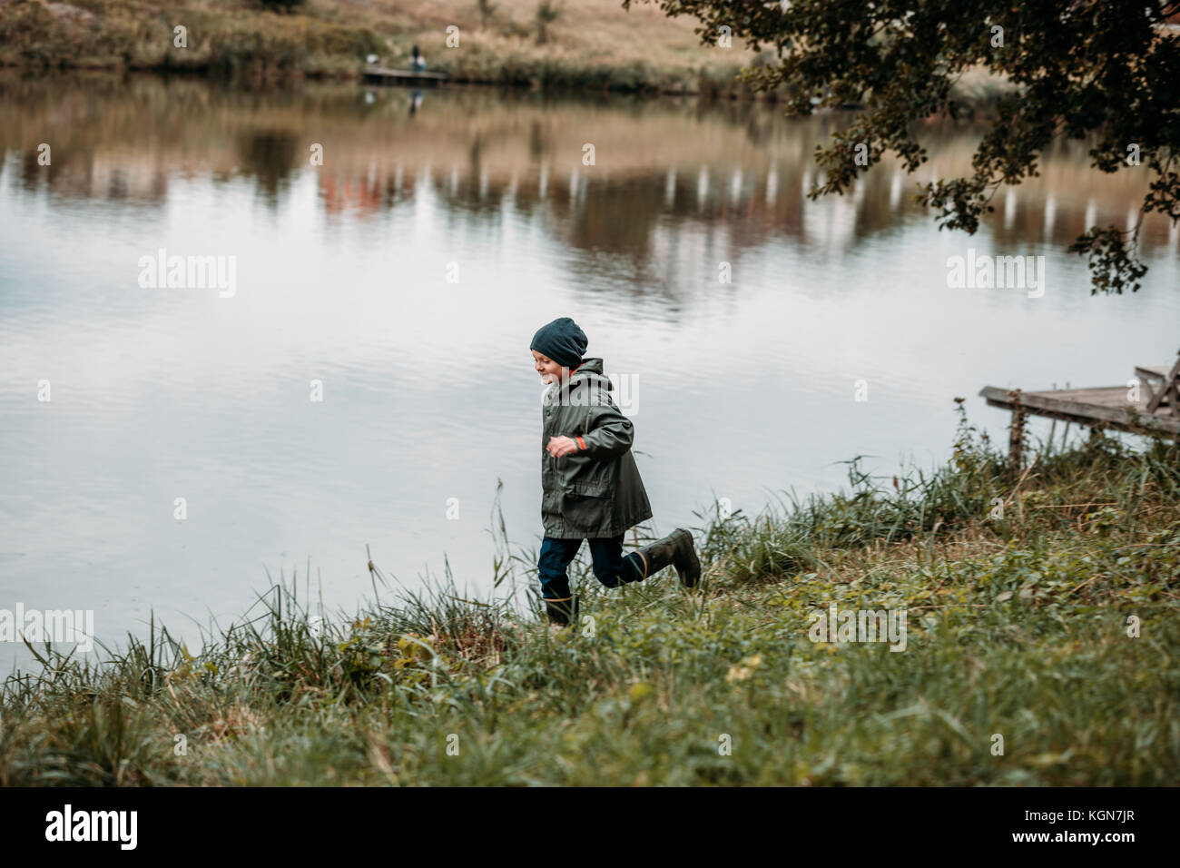 boy running at lake Stock Photo - Alamy