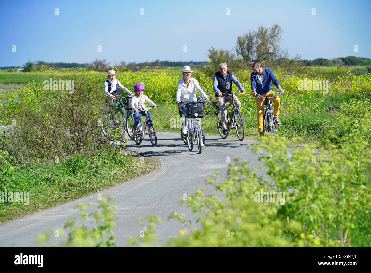 Happy family riding bikes on a beautiful journey Stock Photo - Alamy