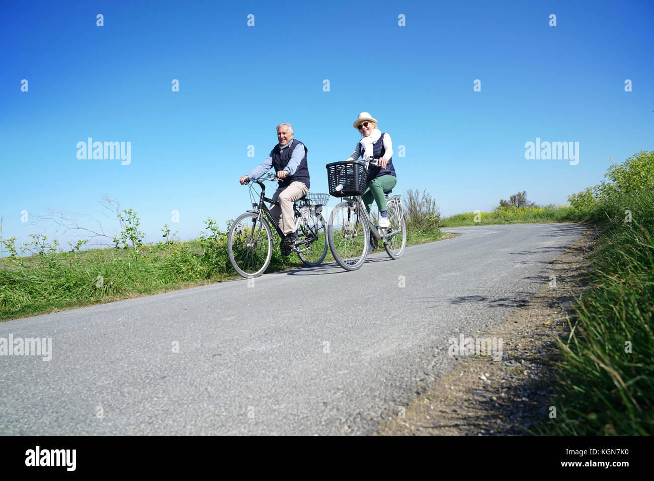 Retired couple cycling on road hi-res stock photography and images - Alamy
