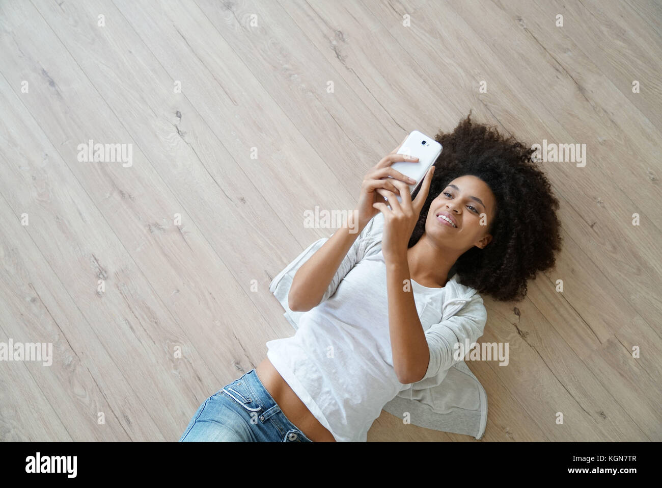 Upper view of woman lying on the back on wooden floor Stock Photo - Alamy