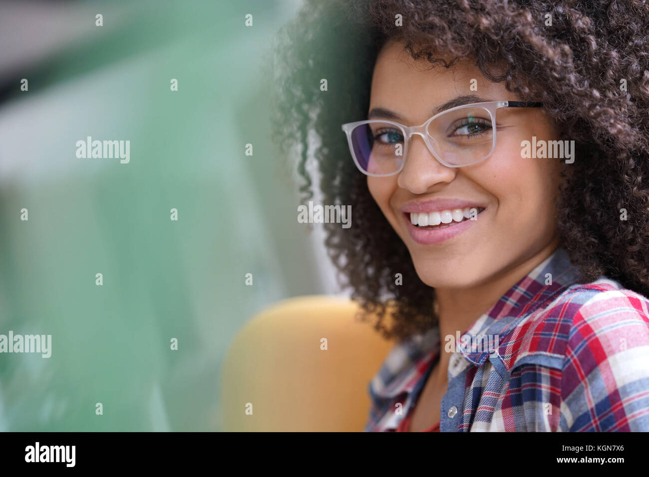 Attractive mixed race woman with eyeglasses relaxing in armchair Stock ... Attractive mixed race woman with eyeglasses relaxing in armchair Stock ...