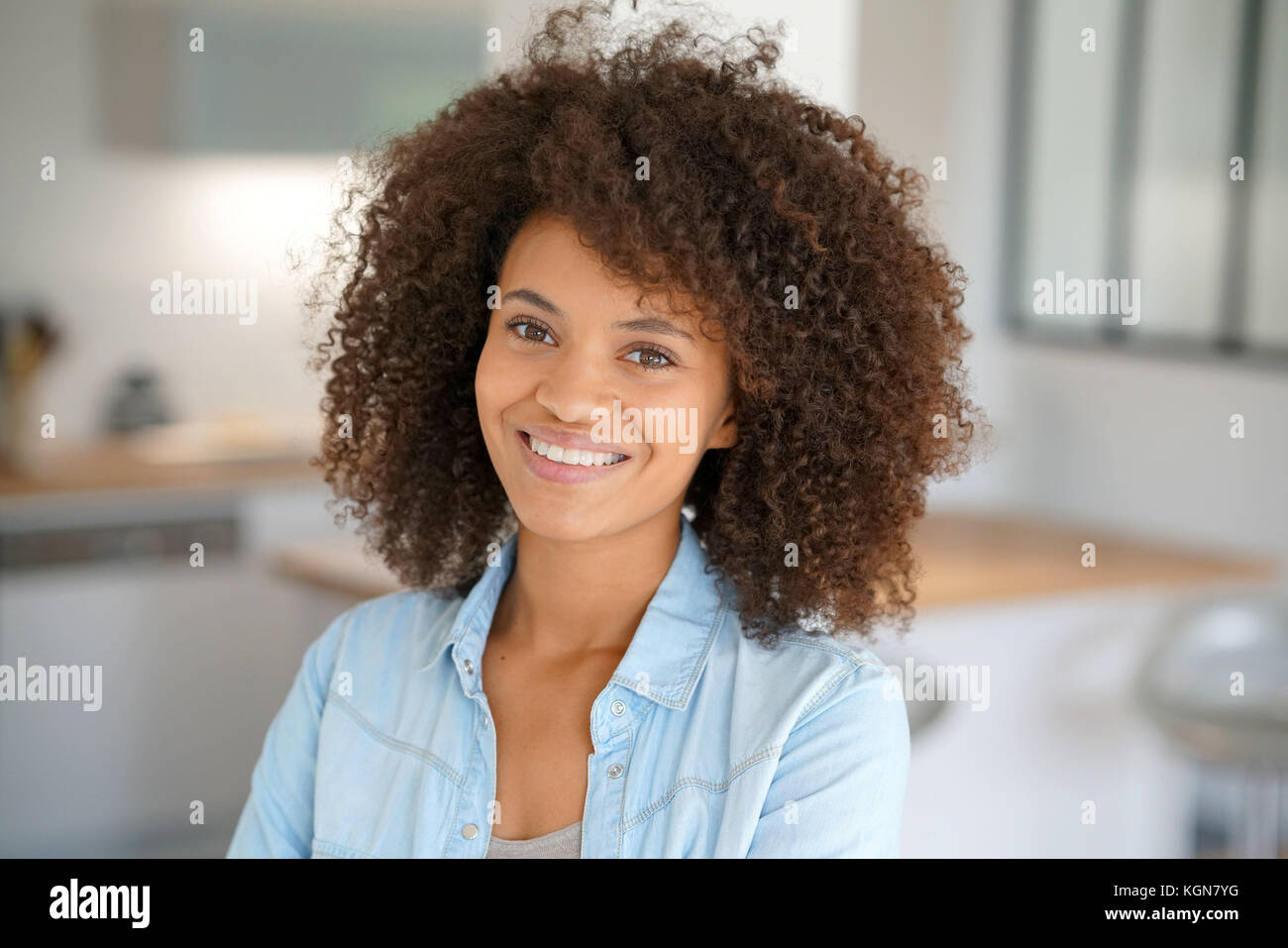 Attractive smiling mixed-race girl at home Stock Photo - Alamy