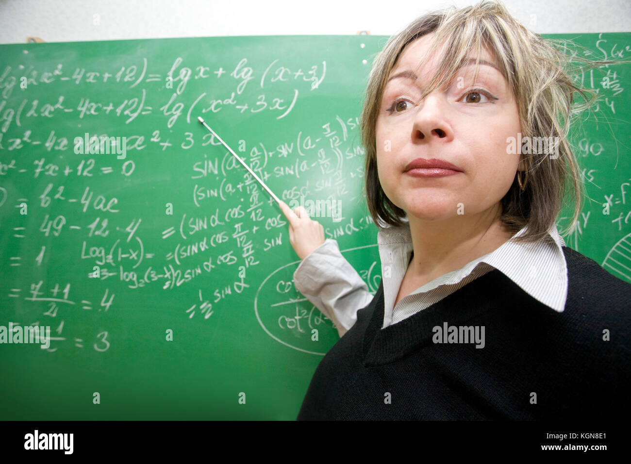 Smiley teacher hands chalk standing at the blackboard Stock Photo - Alamy