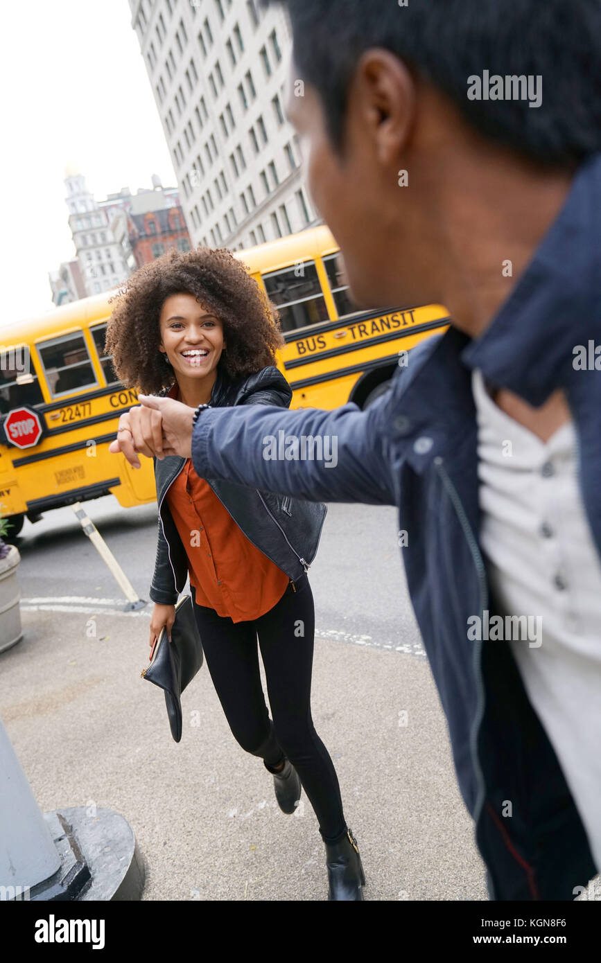 Man pulling on girlfriend's arm in New york city street Stock Photo - Alamy