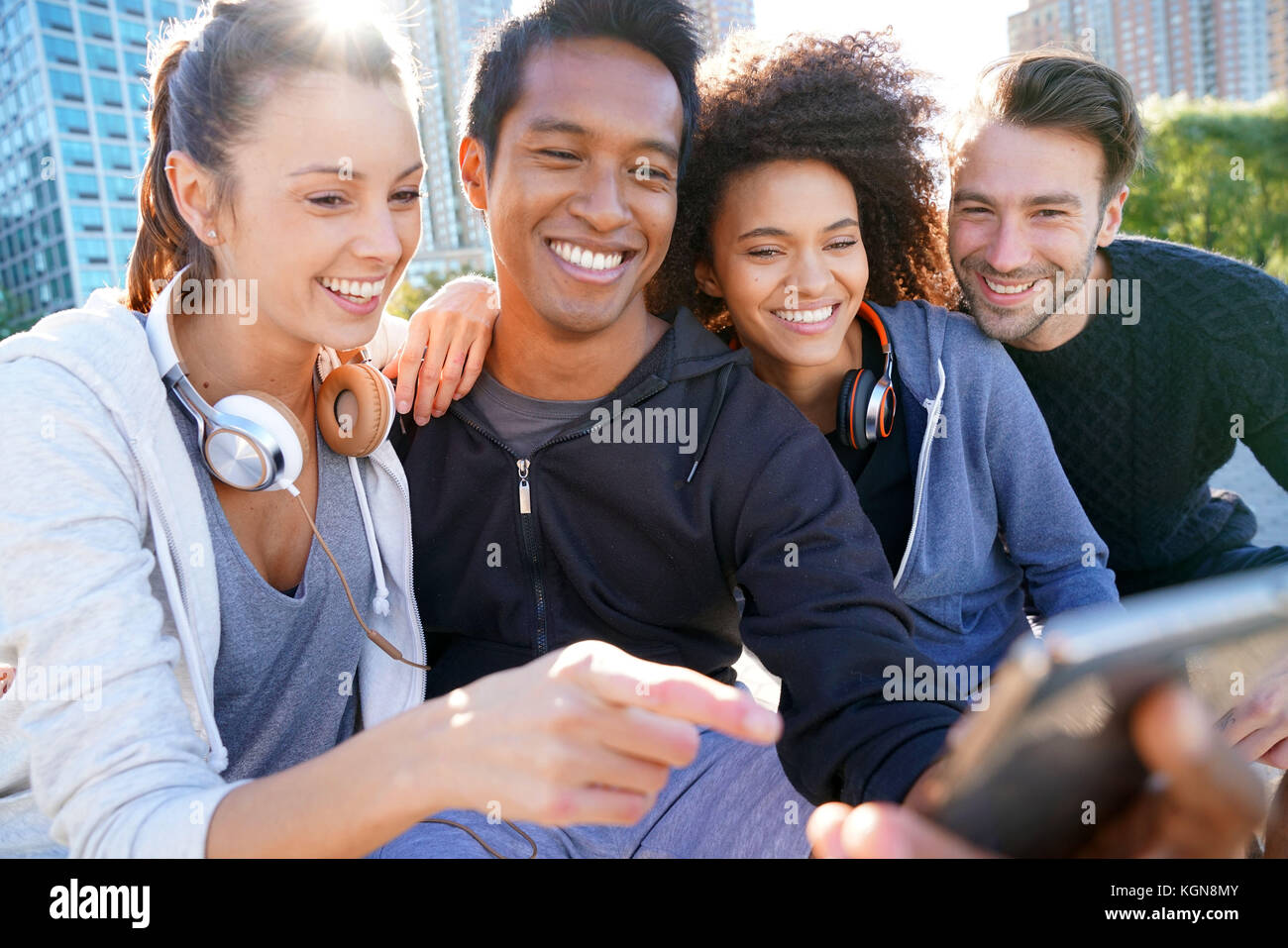 Group of friends in casual outfit taking selfie picture with smartphone ...