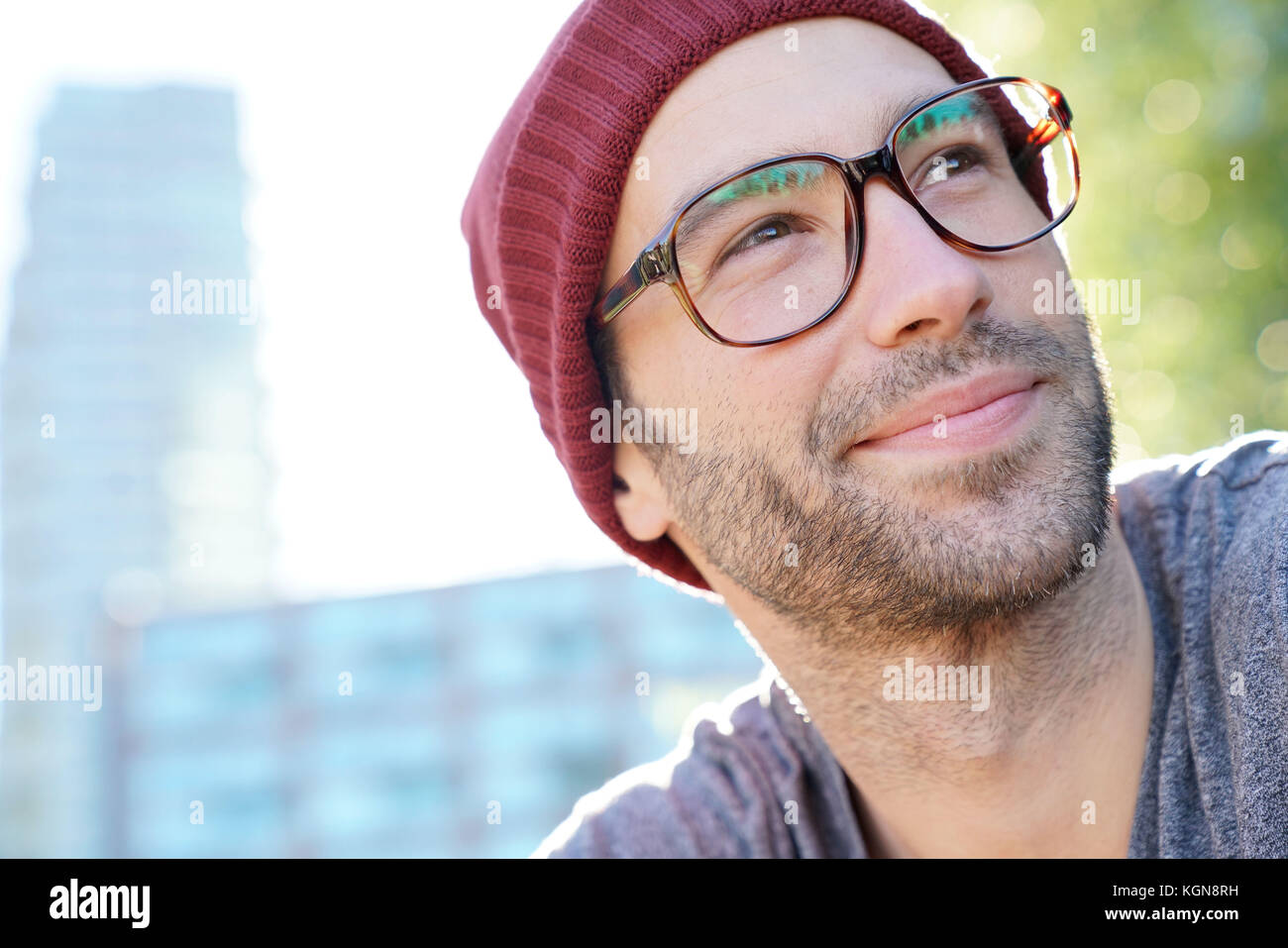 Hipster guy with eyeglasses and cap relaxing in park Stock Photo - Alamy