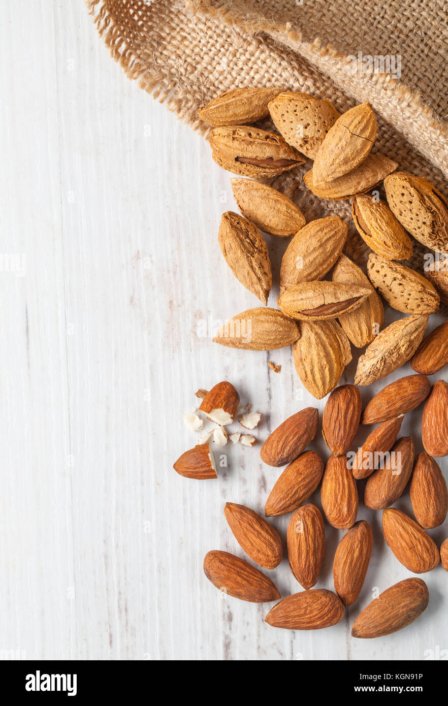 Almonds on wooden background Stock Photo - Alamy