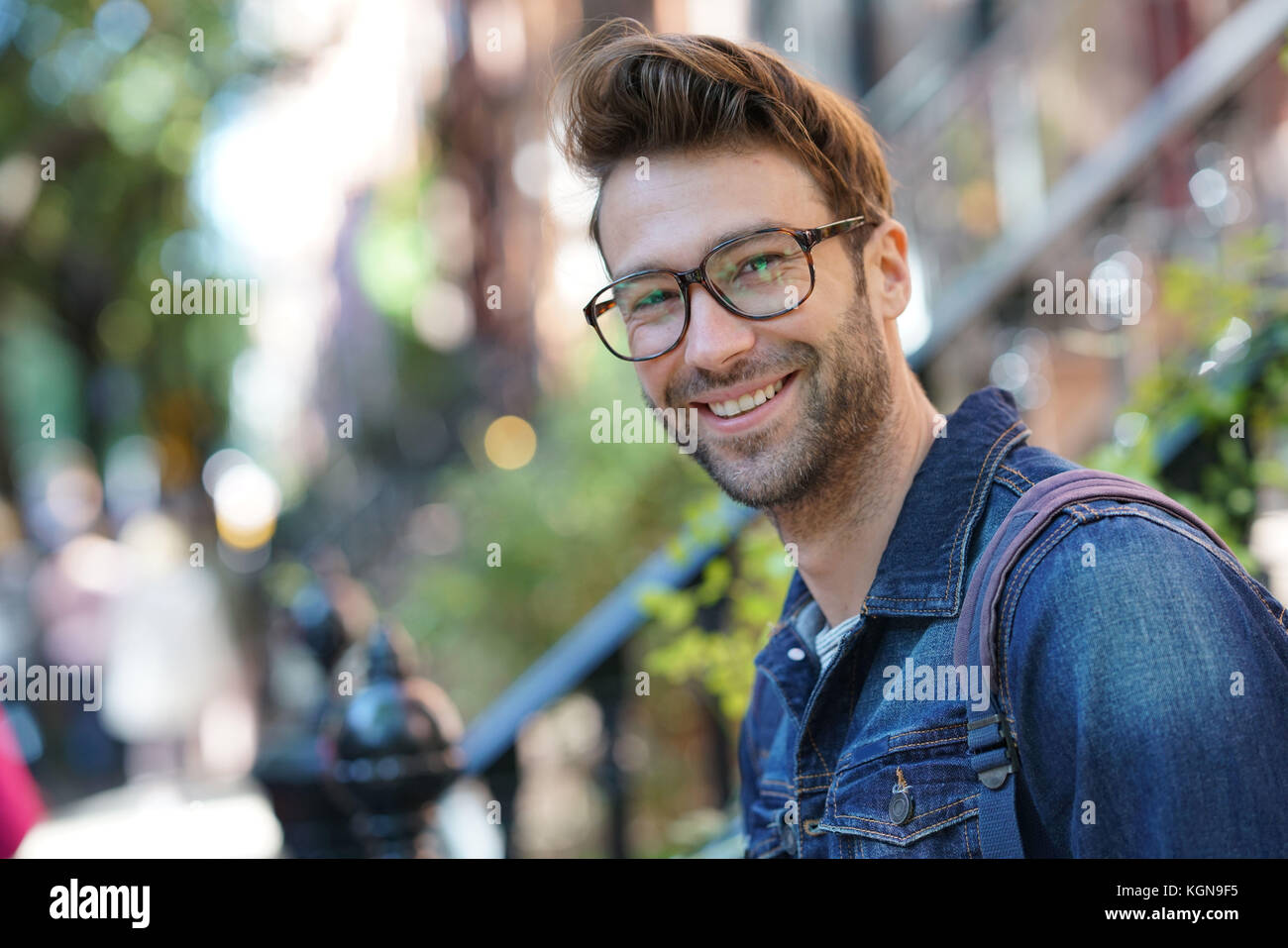 Cheerful man walking in the street, NYC tour Stock Photo - Alamy
