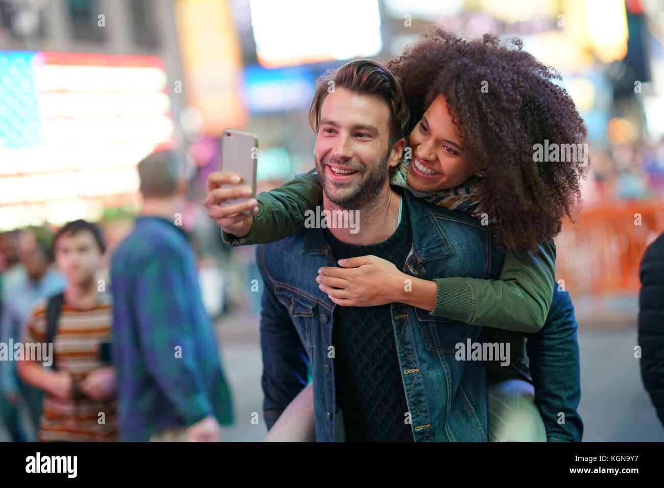 Couple at Times Square taking selfie picture Stock Photo - Alamy