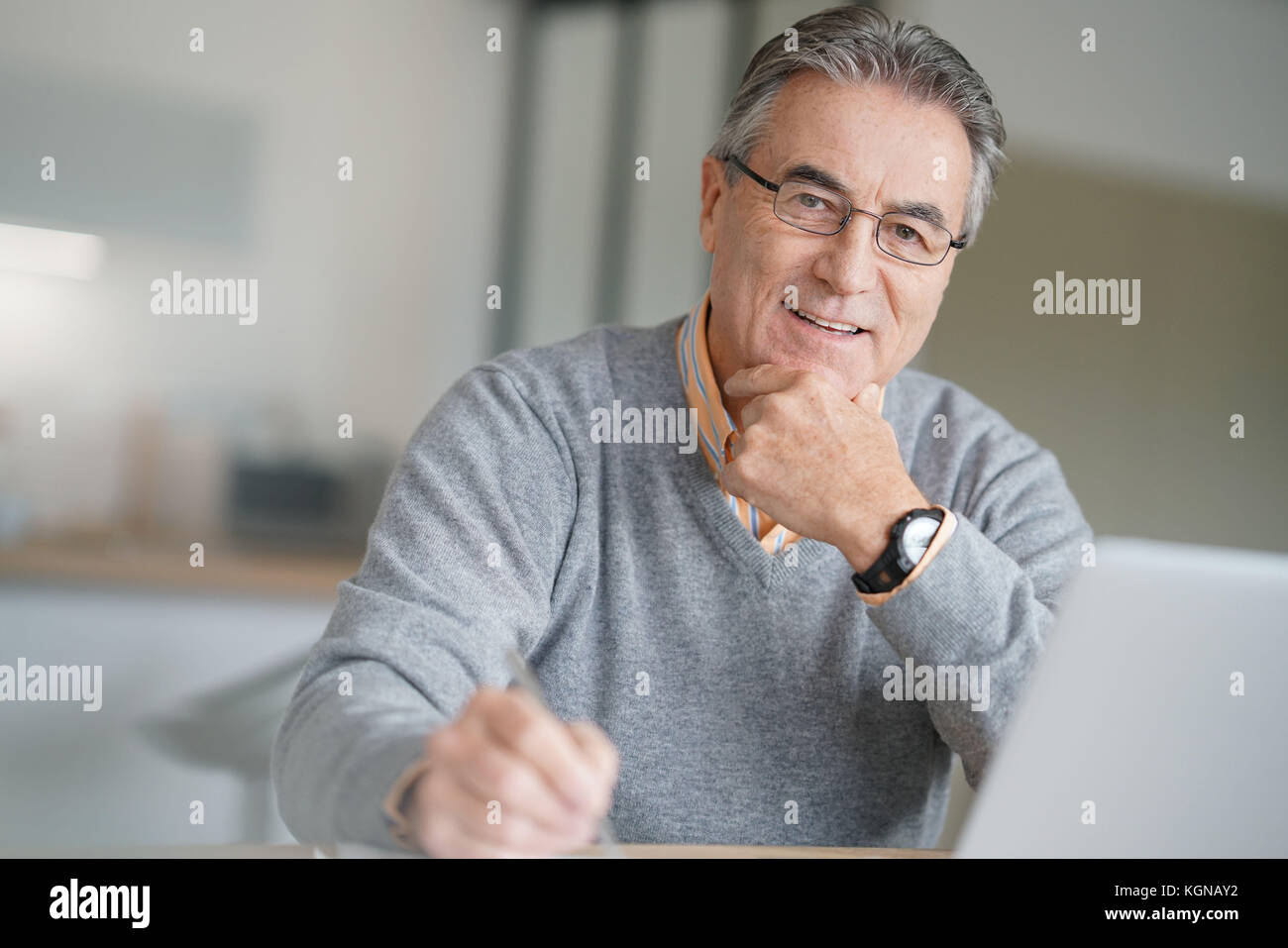Senior man at home connected on laptop computer Stock Photo - Alamy