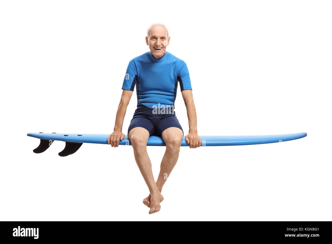 Elderly surfer sitting on a surfboard and smiling isolated on white ...