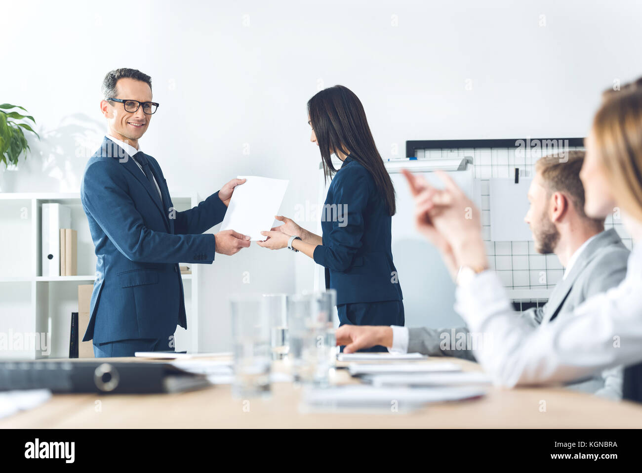 boss rewarding manageress Stock Photo - Alamy