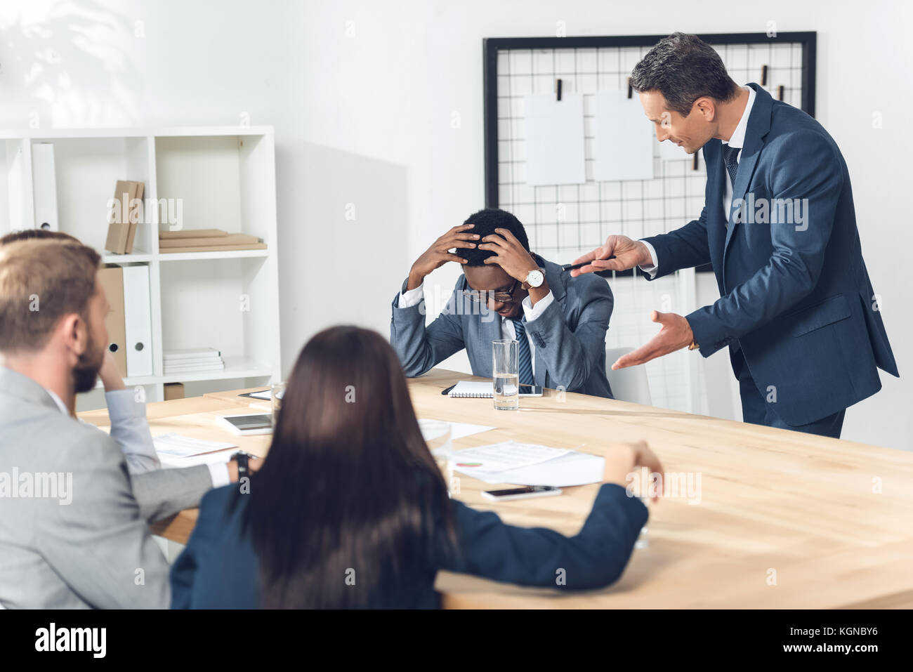 boss abusing on african american manager Stock Photo - Alamy