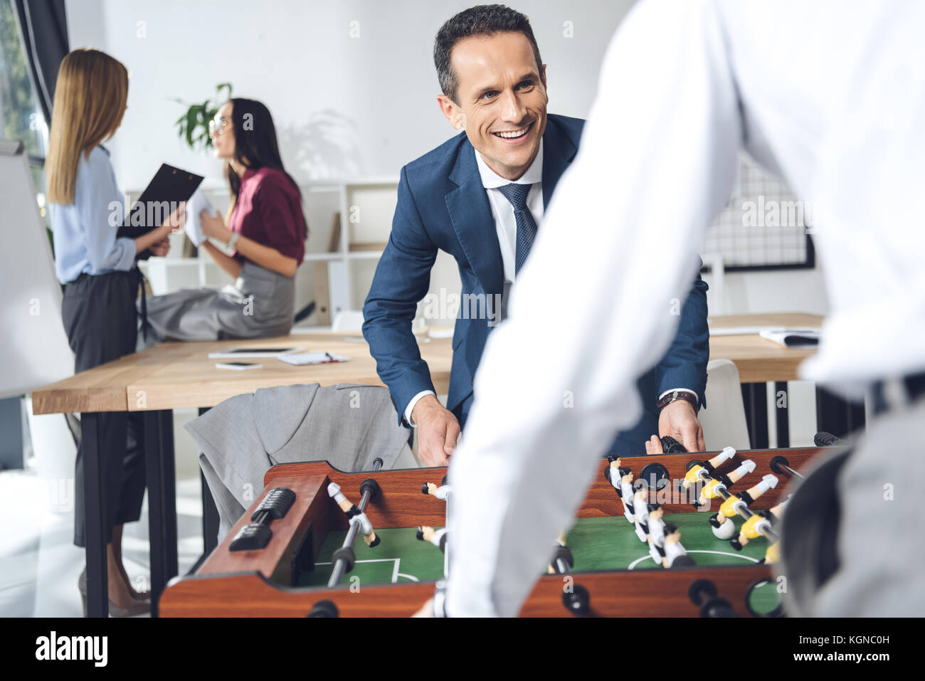 businessmen playing table football Stock Photo - Alamy