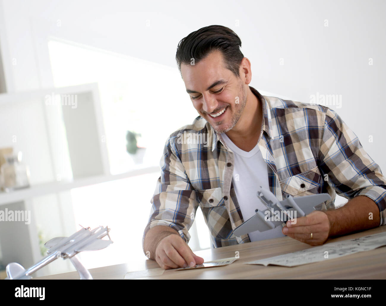 Man reading model building instructions Stock Photo - Alamy