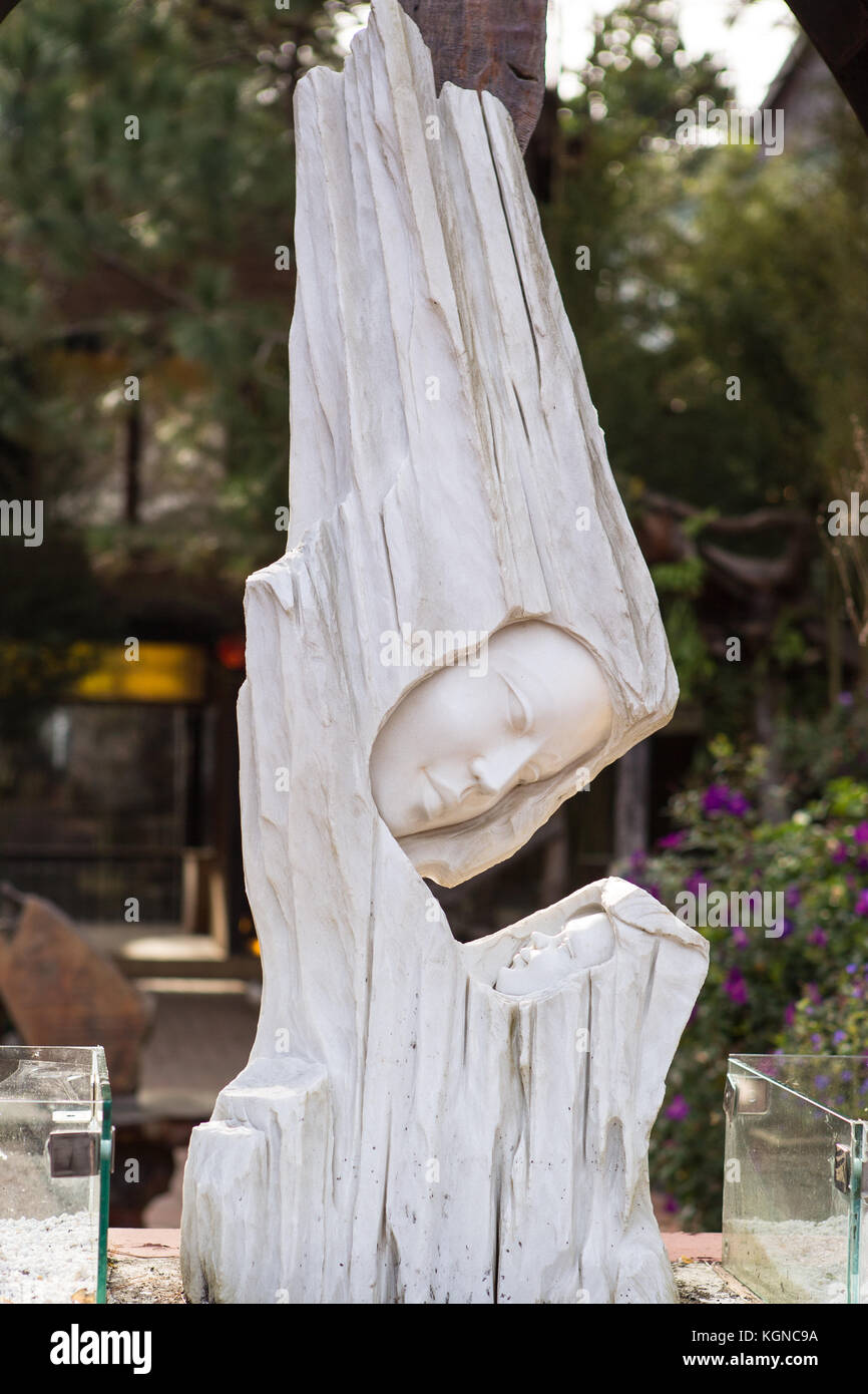 a small white sculpture of face in Asia Stock Photo - Alamy