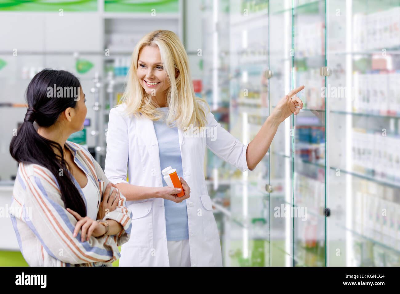 pharmacist consulting customer in drugstore Stock Photo - Alamy