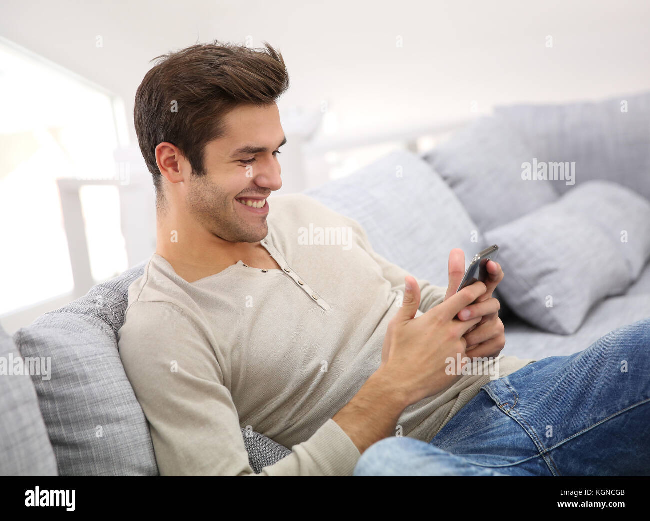 Man with smartphone being happy as reading message Stock Photo - Alamy