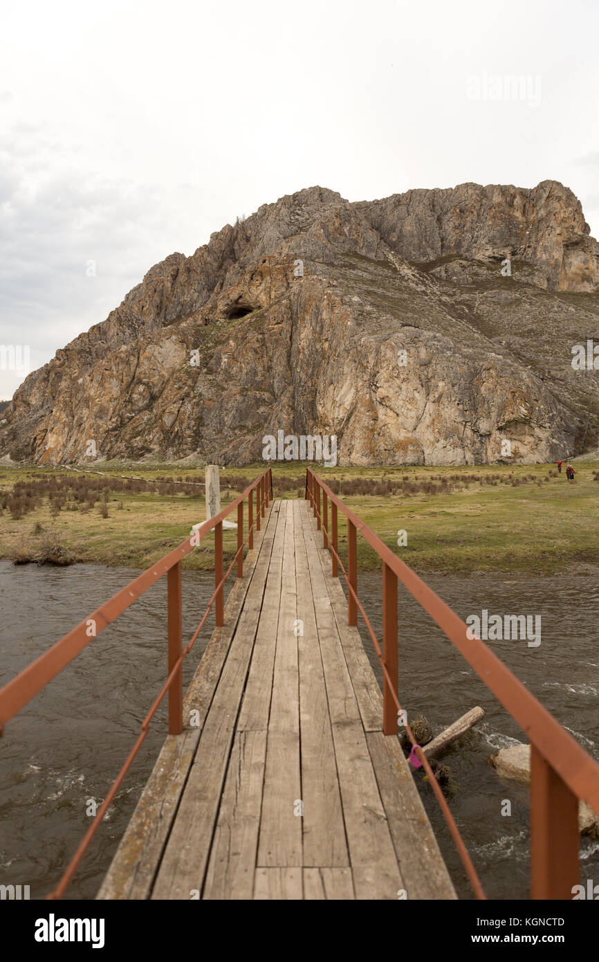 The old hanging footbridge across a small river Stock Photo - Alamy