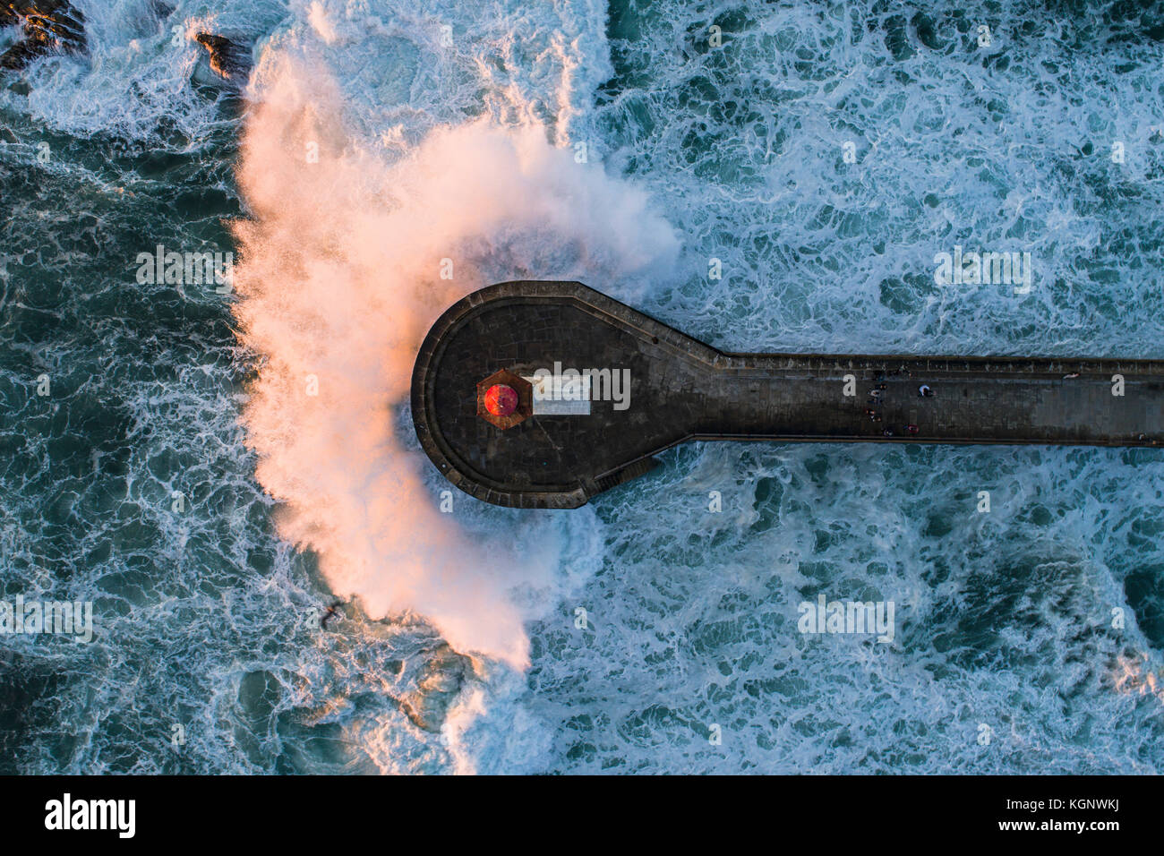 Directly above view of wave splashing on pier in sea, Porto, Portugal ...