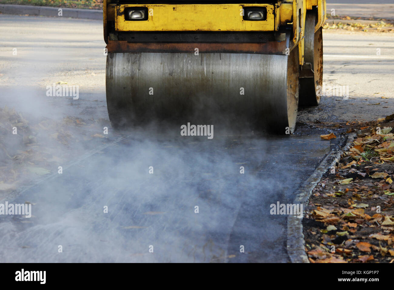 Mini compactor tires the upper layer of asphalt in the construction of ...