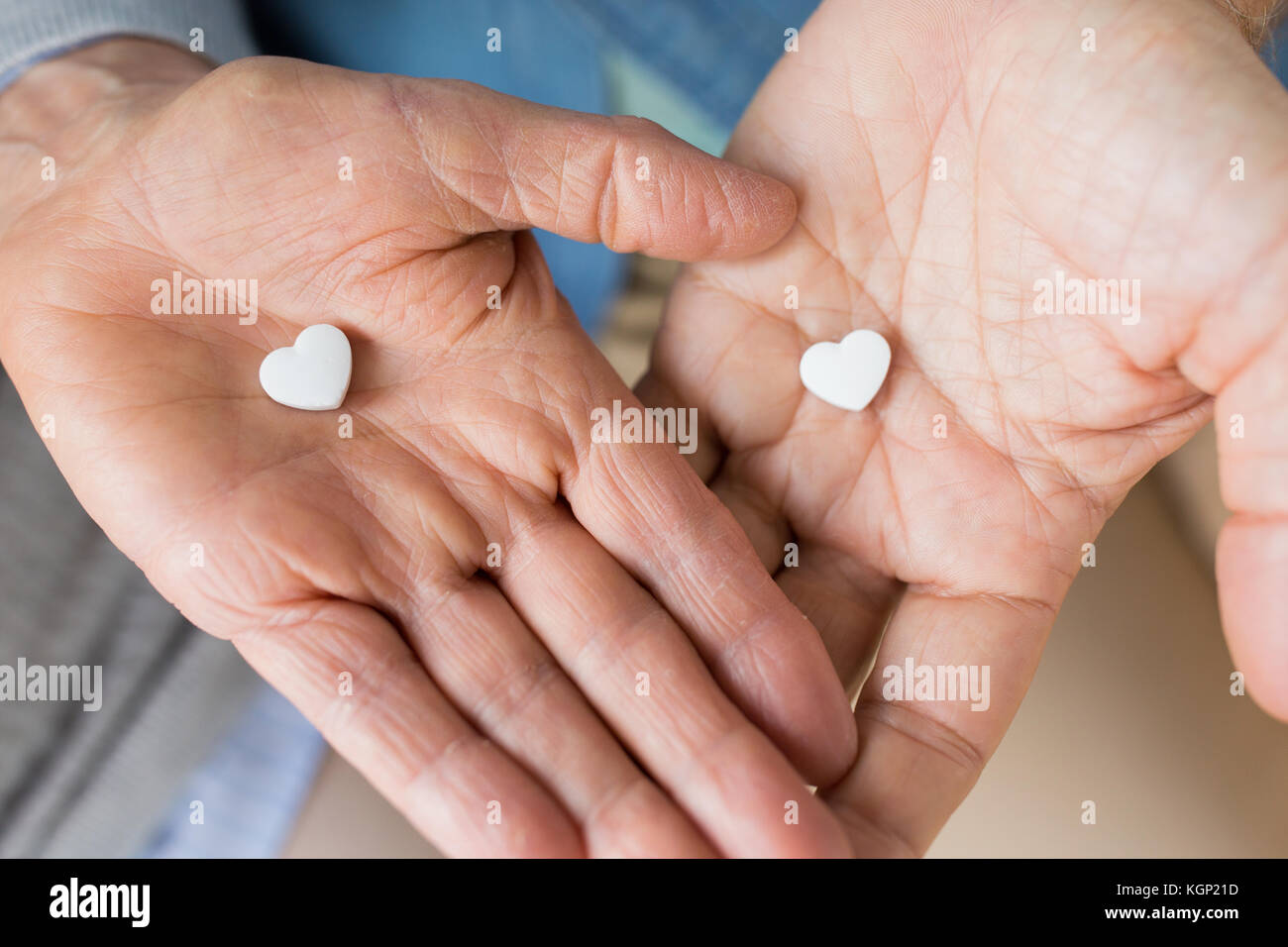 close up of couple hands with heart shaped pill Stock Photo - Alamy