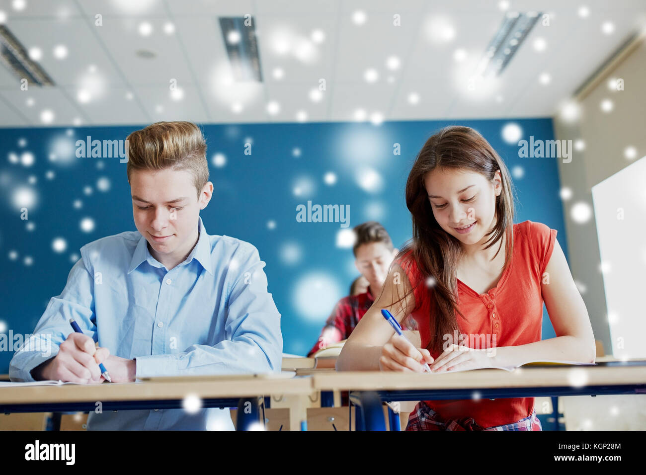 group of students with books writing school test Stock Photo - Alamy