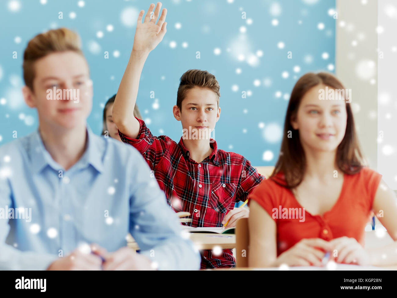 student boy raising hand at school lesson Stock Photo - Alamy