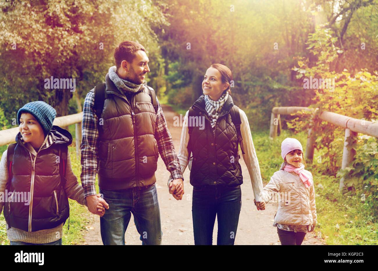happy family with backpacks hiking Stock Photo - Alamy