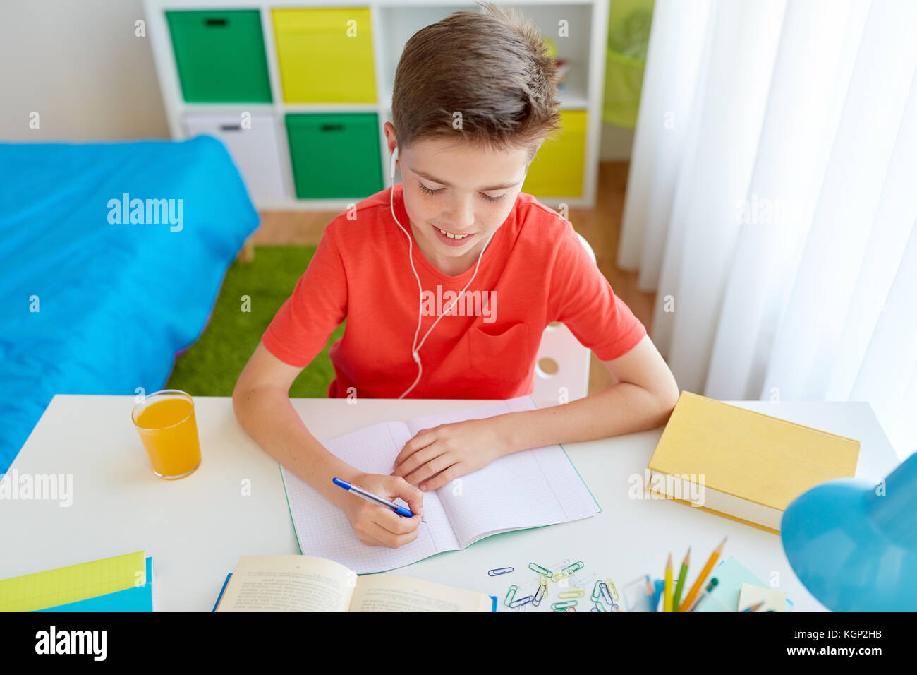 happy student boy writing to notebook at home Stock Photo - Alamy