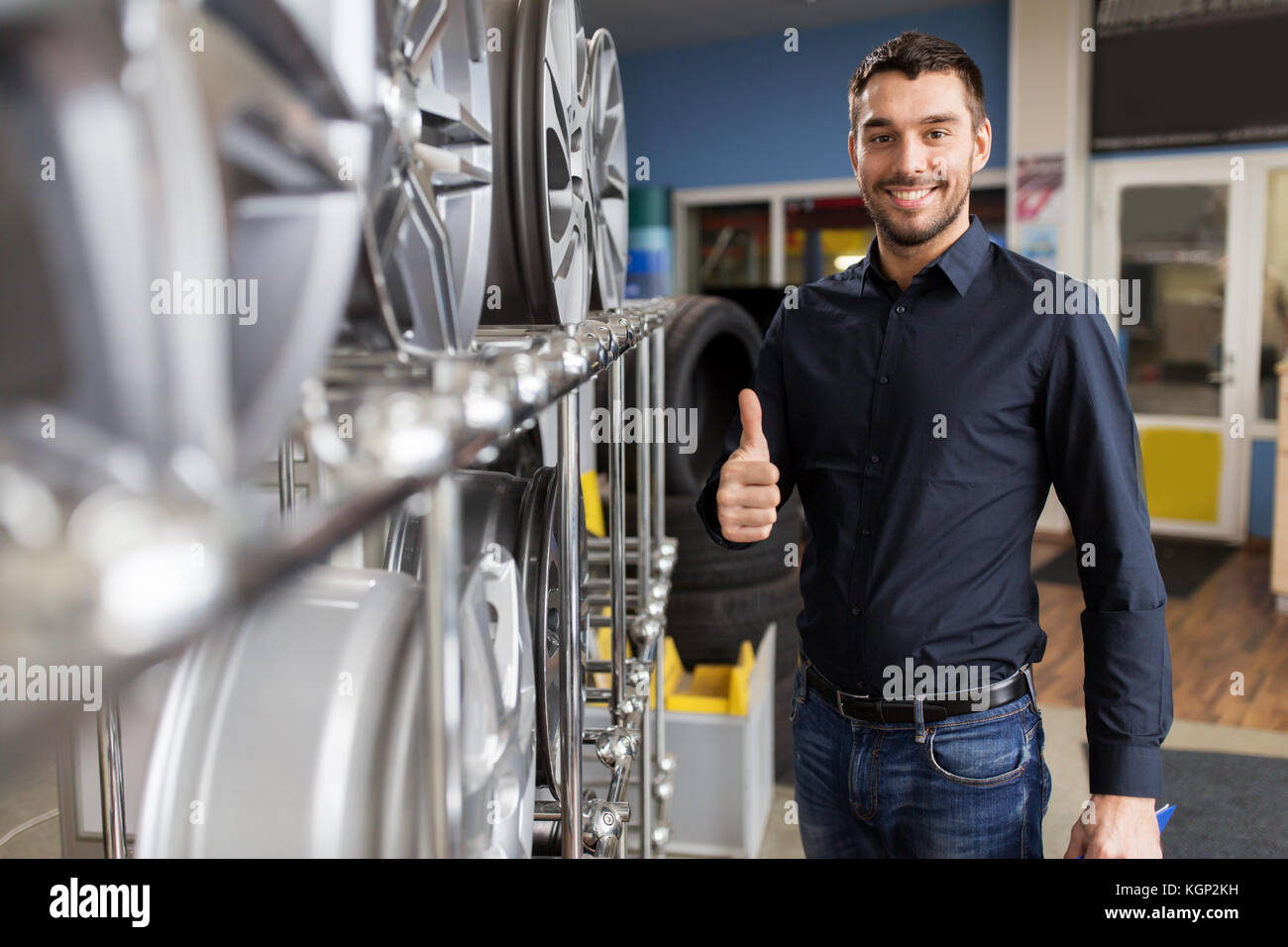 male customer choosing wheel rims at car service Stock Photo - Alamy