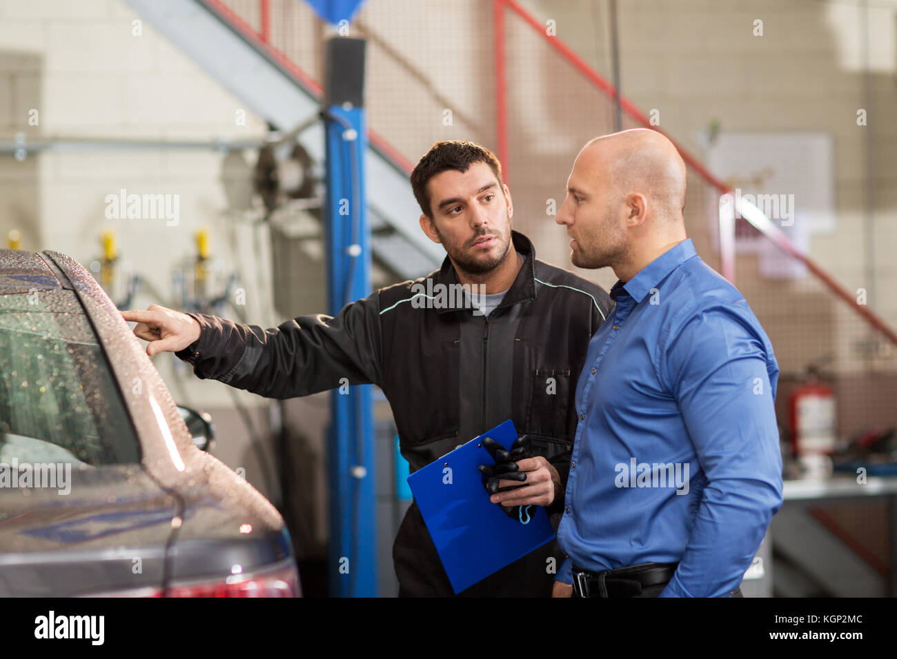 auto mechanic and customer at car shop Stock Photo - Alamy