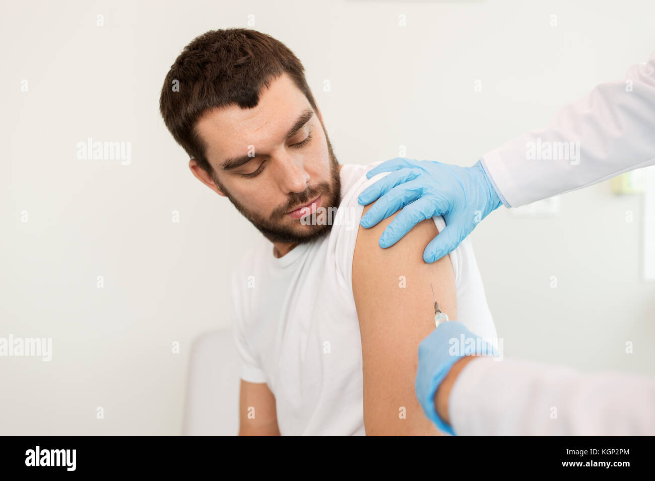 male patient and doctor hands with syringe Stock Photo - Alamy