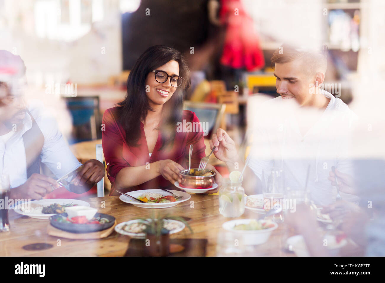 happy friends eating at restaurant Stock Photo - Alamy