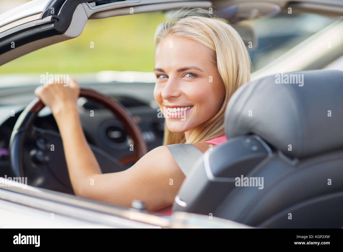 happy young woman driving convertible car Stock Photo - Alamy