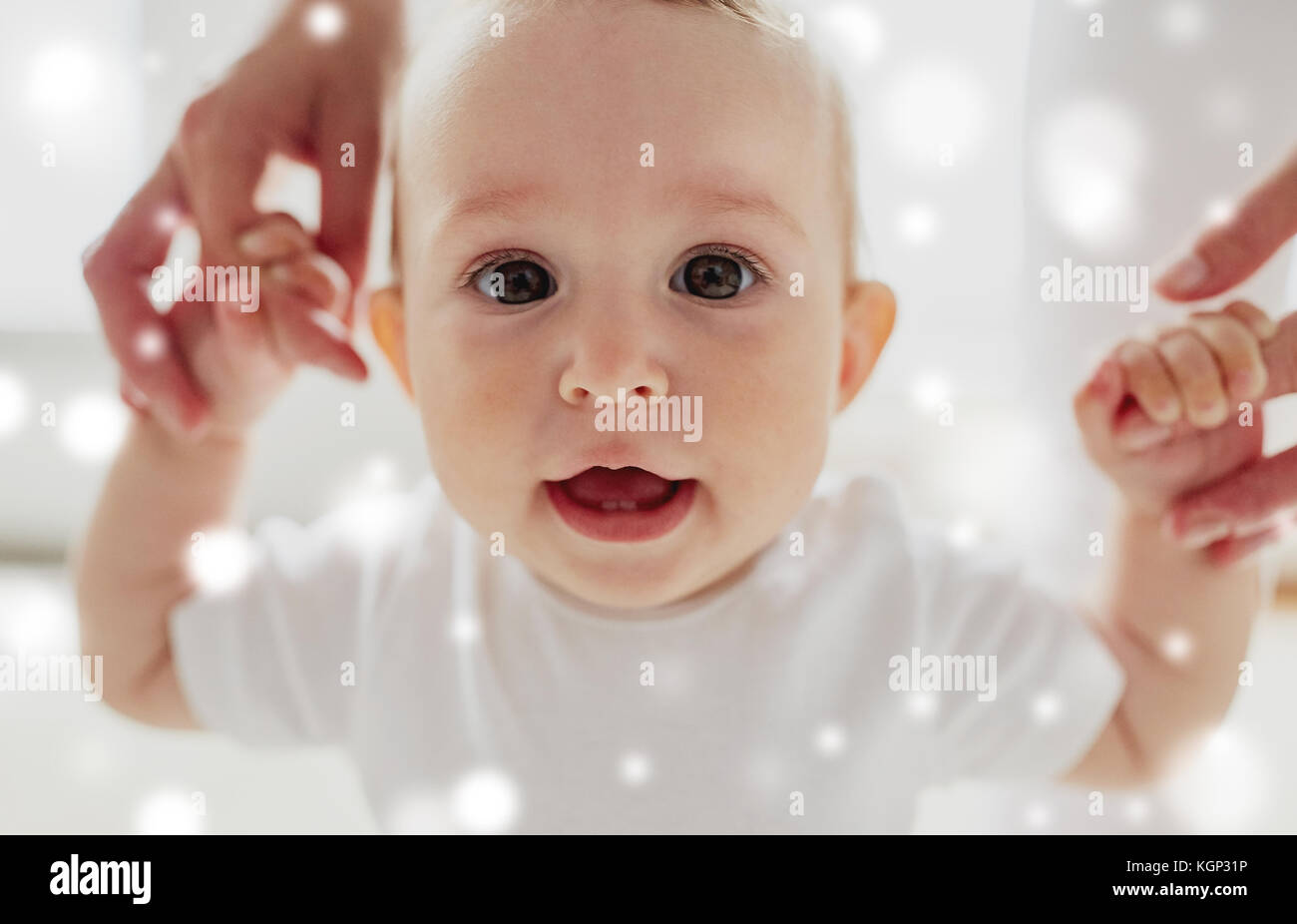 happy baby learning to walk with mother help Stock Photo - Alamy