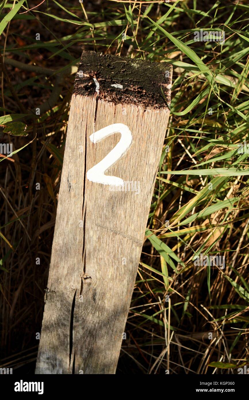 White number 2 on old wooden post at Fowlmere Nature reserve, Cambridge ...