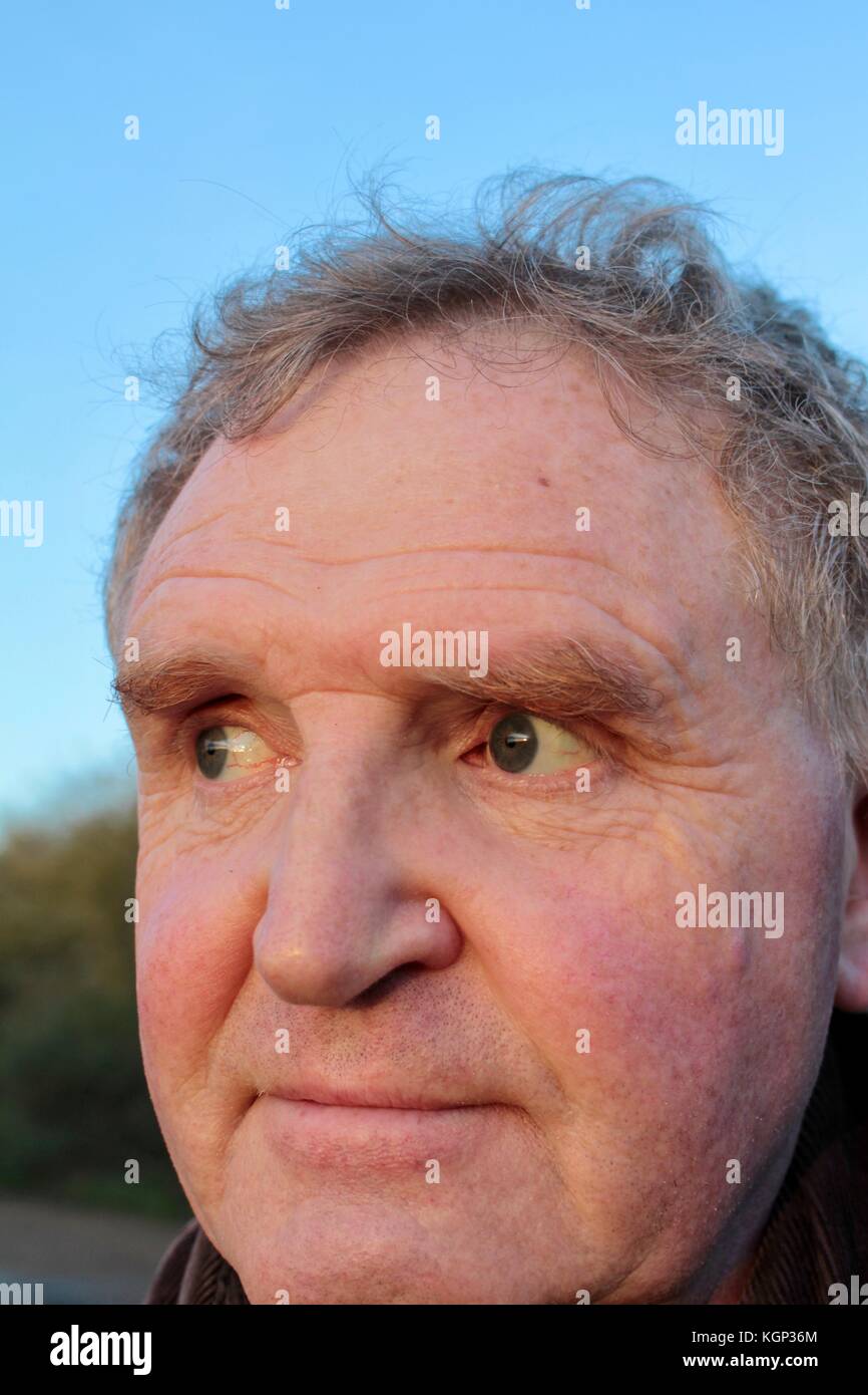 Close up of white 60's man looking in sunset at ducks on a lake Stock ...
