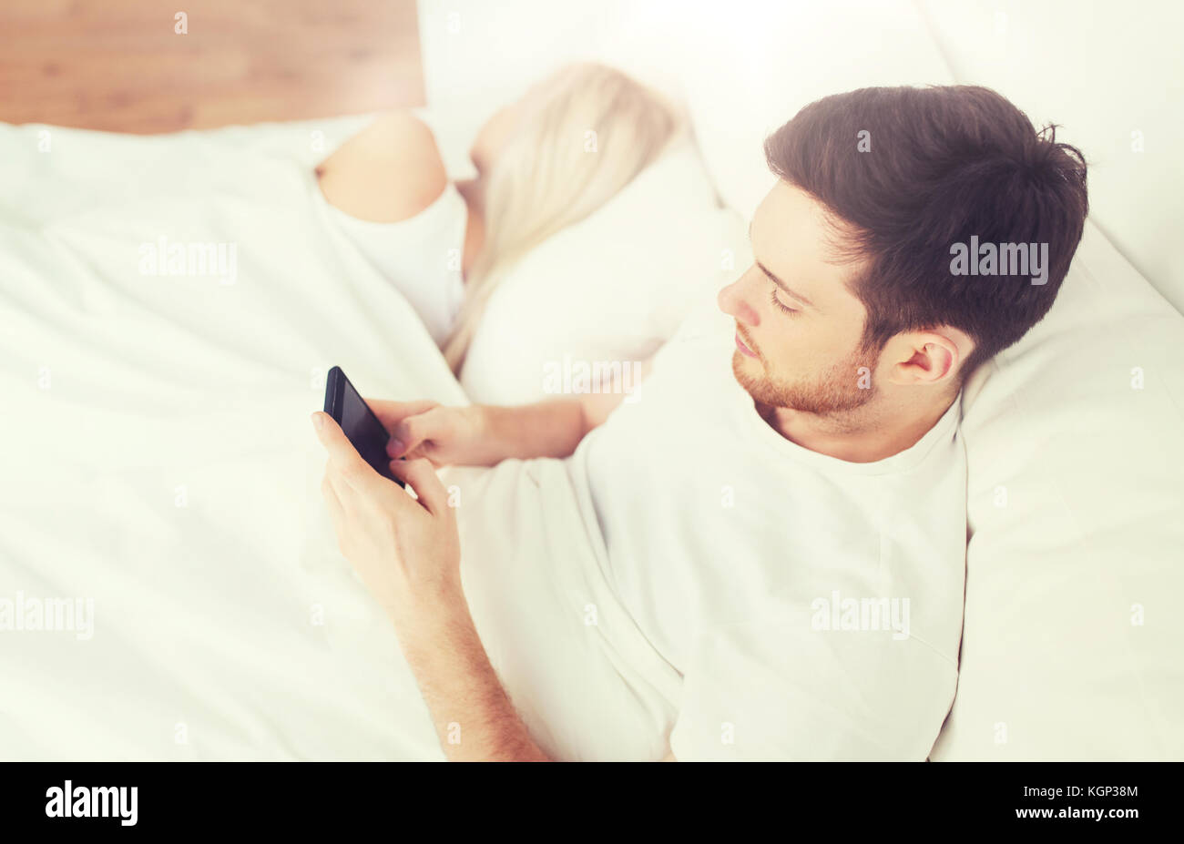 man texting message while woman is sleeping in bed Stock Photo - Alamy man texting message while woman is sleeping in bed Stock Photo - Alamy
