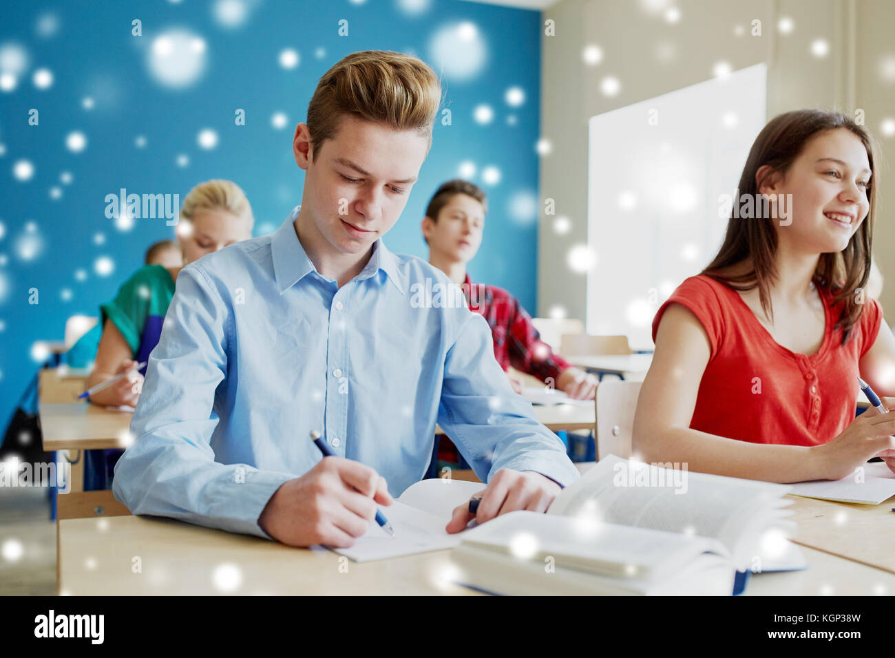 group of students with books writing school test Stock Photo - Alamy