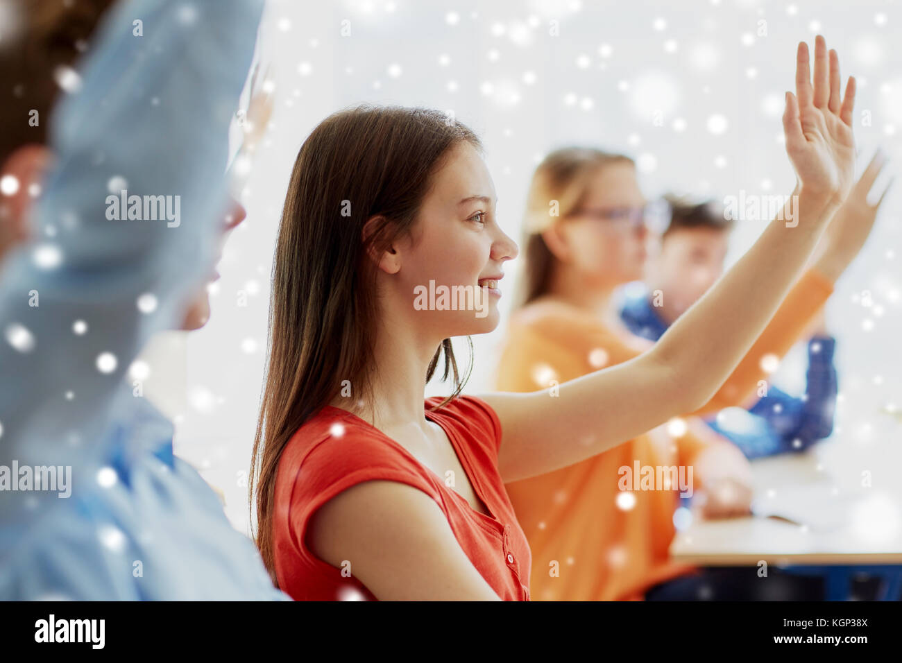 student girl raising hand at school lesson Stock Photo - Alamy