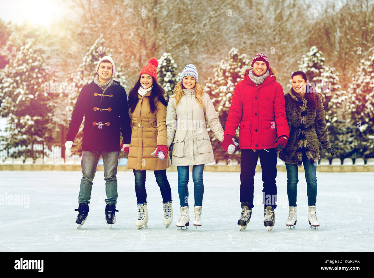 happy friends ice skating on rink outdoors Stock Photo - Alamy