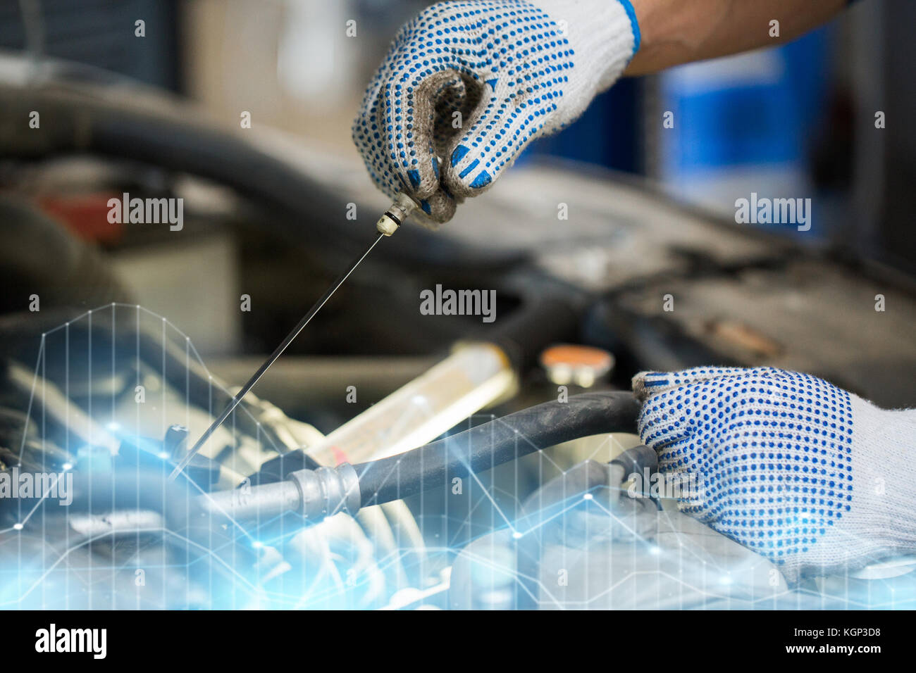 mechanic with dipstick checking motor oil level Stock Photo - Alamy