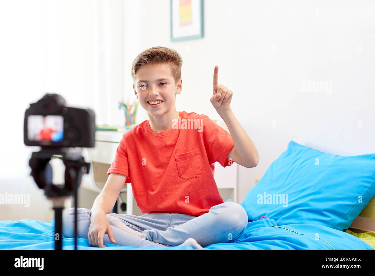 happy boy with camera recording video at home Stock Photo - Alamy