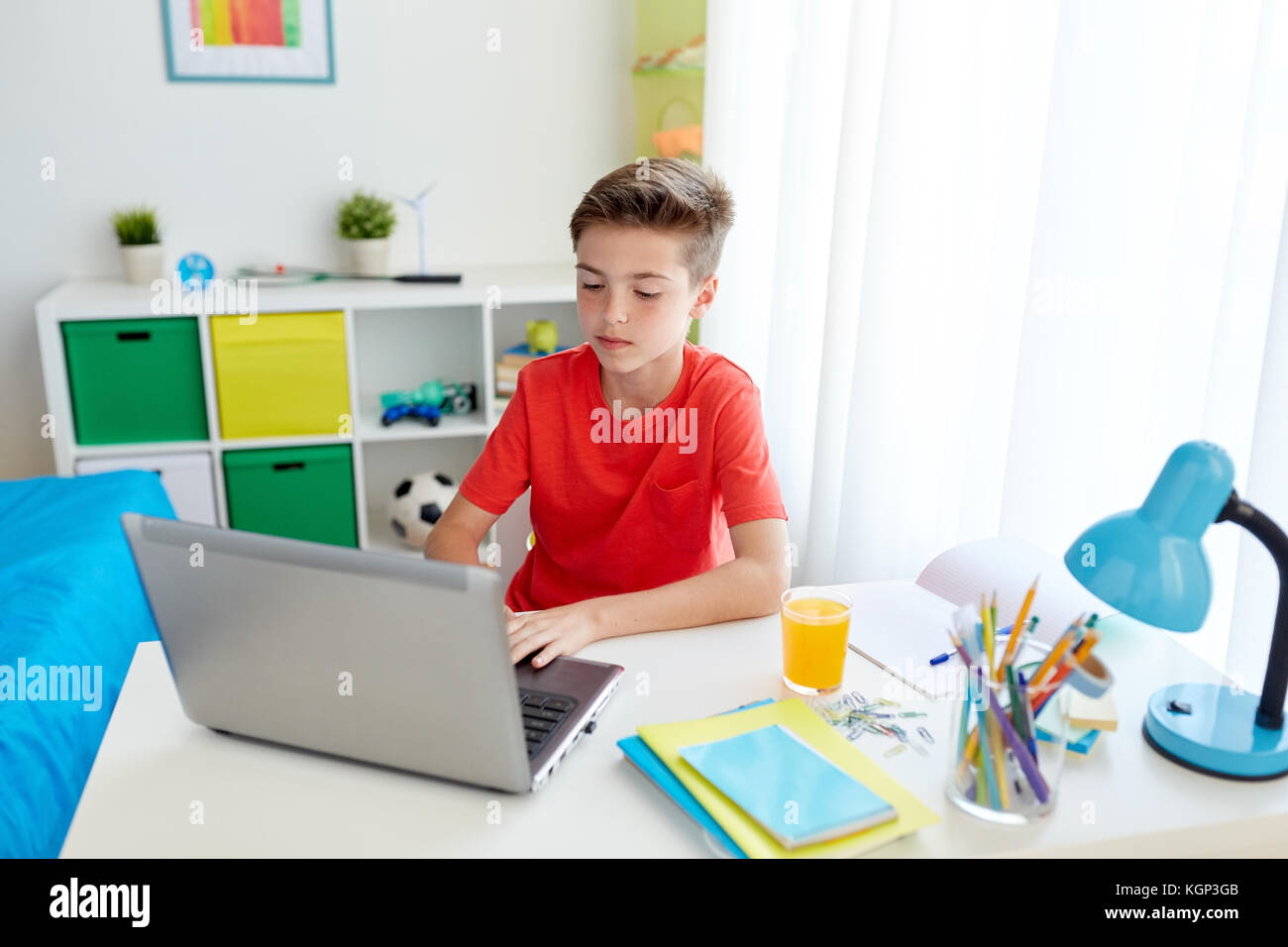 student boy typing on laptop computer at home Stock Photo - Alamy