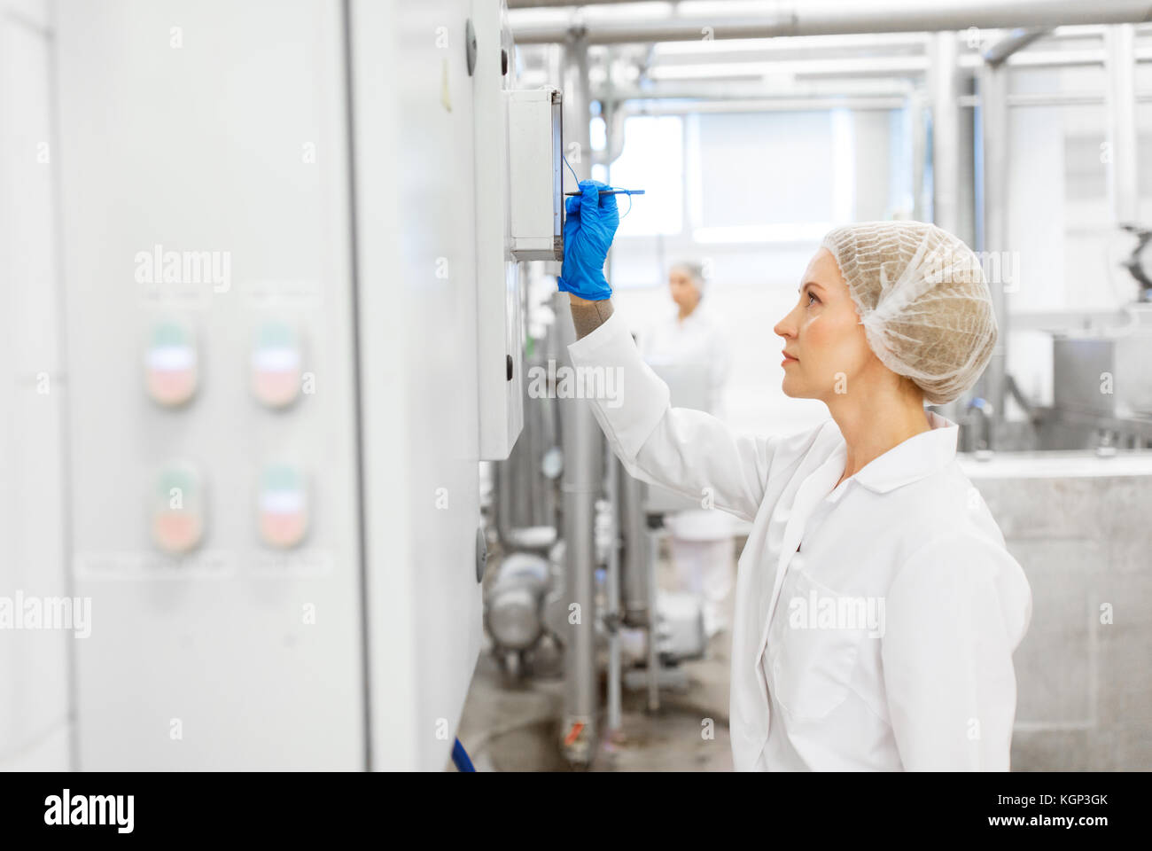 woman programming computer at ice cream factory Stock Photo - Alamy