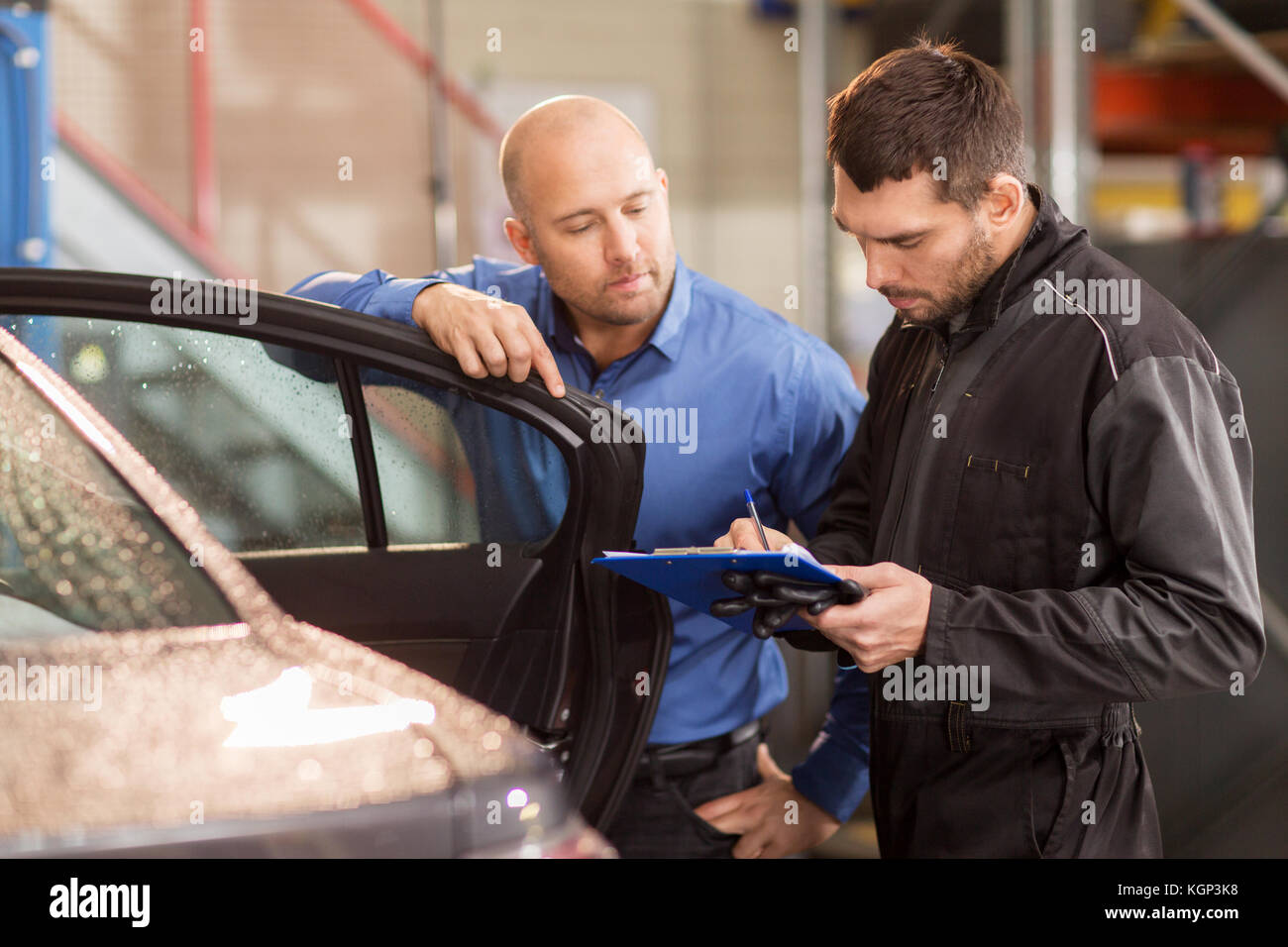 auto mechanic and customer at car shop Stock Photo - Alamy