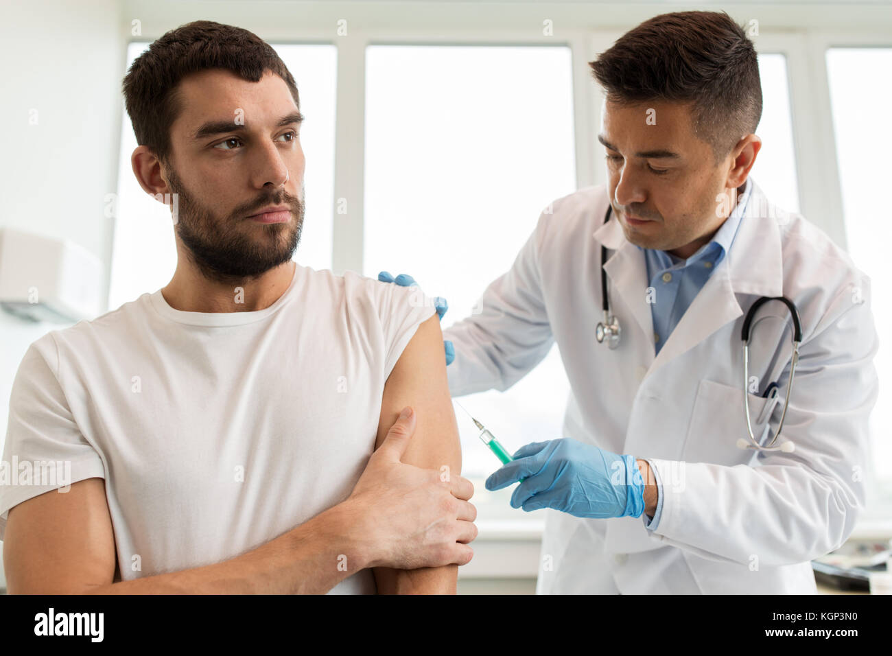 patient and doctor with syringe doing vaccination Stock Photo - Alamy