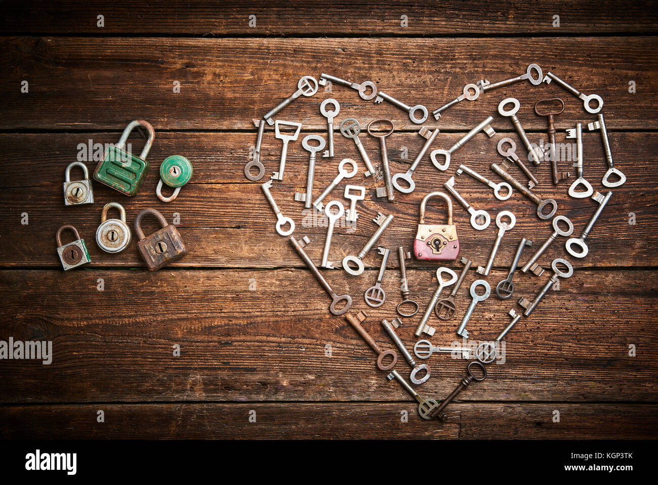 Old keys in a heart shape, on a wood surface, vintage look Stock Photo ...